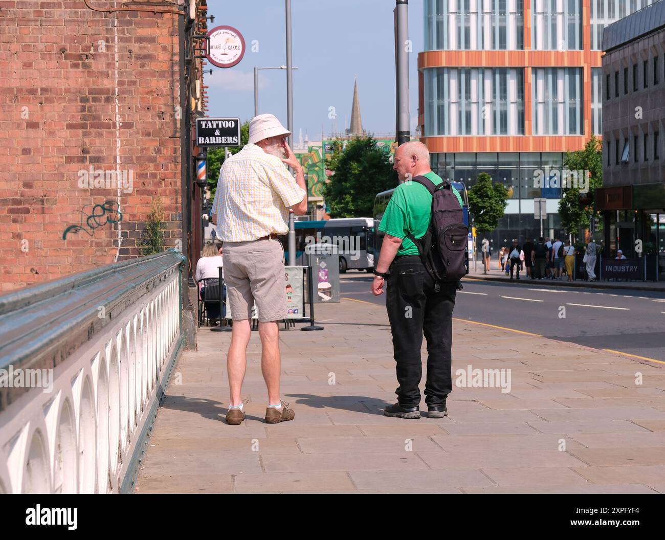 Two old men talking on a sidewalk in Nottingham City center, UK Stock ...