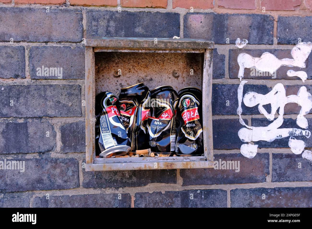 Dented beer cans in a wall cavity Stock Photo - Alamy