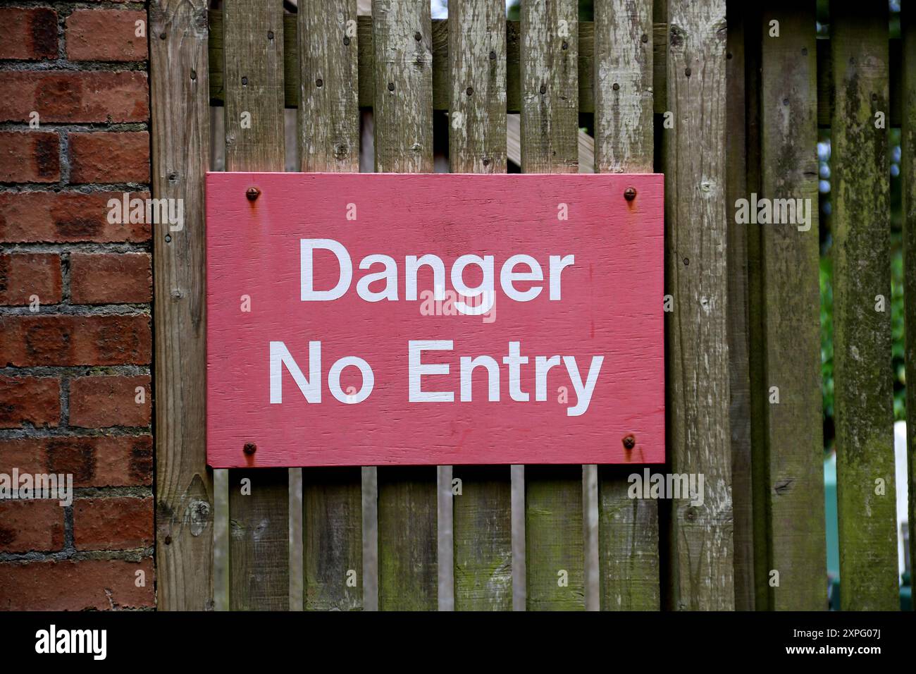 Danger No Entry signboard attached to an old country estate timber gate ...