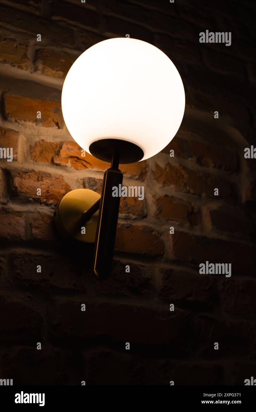 Classic bra lamp on brick wall. Light in the darkness. Interior ...