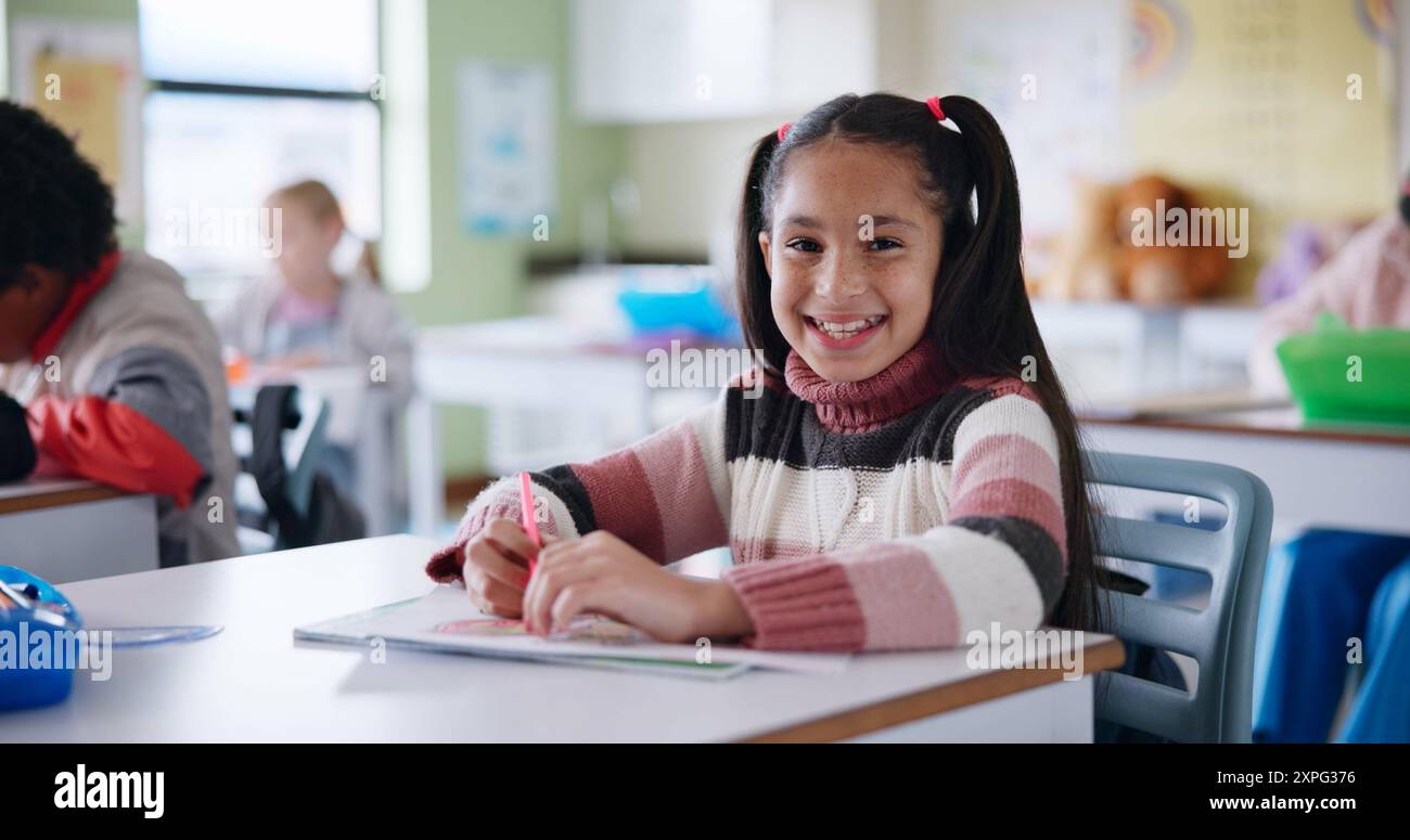 Portrait, girl and student in classroom, education and writing with ...