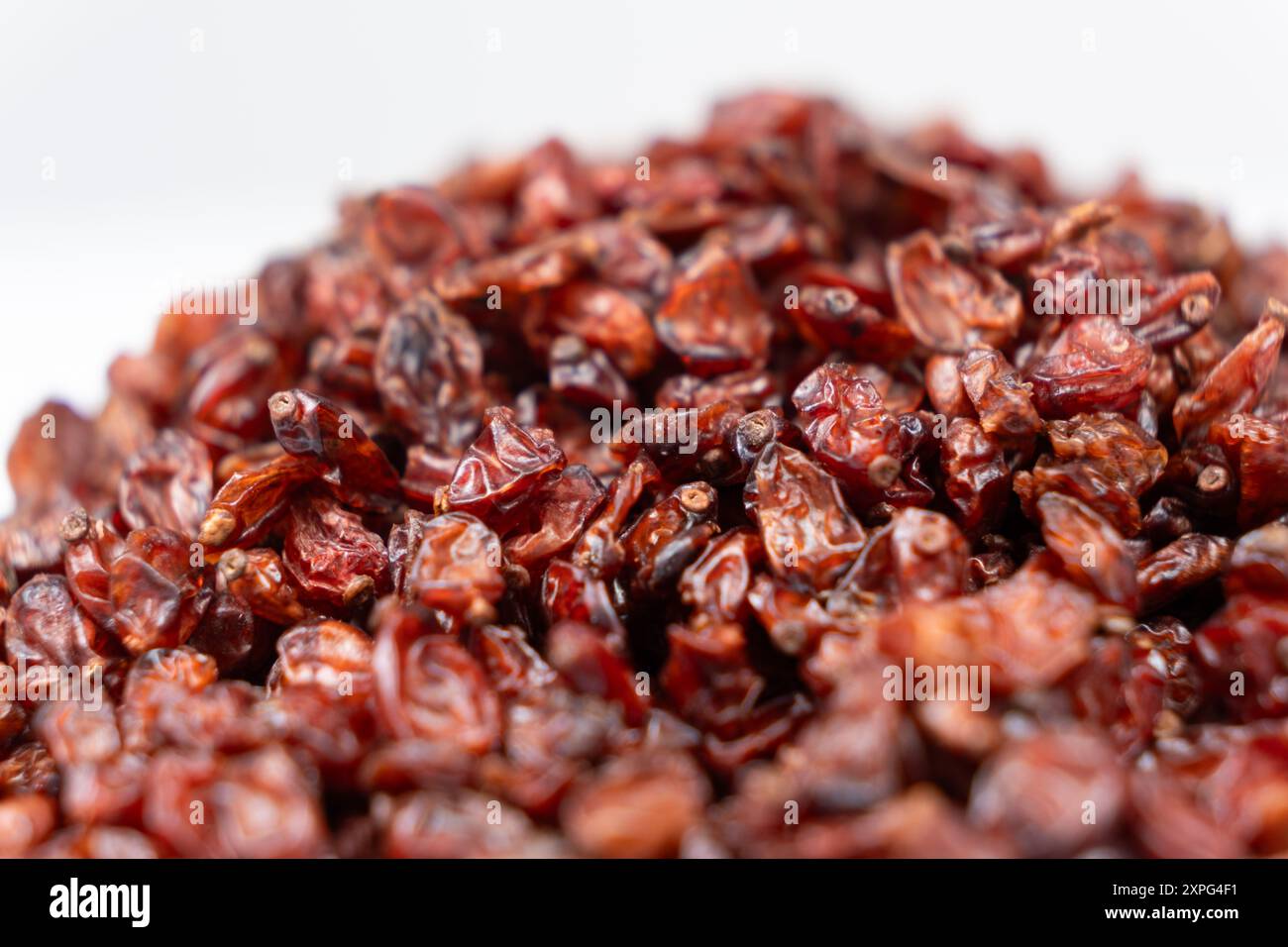 Red dried barberry on white background Stock Photo - Alamy