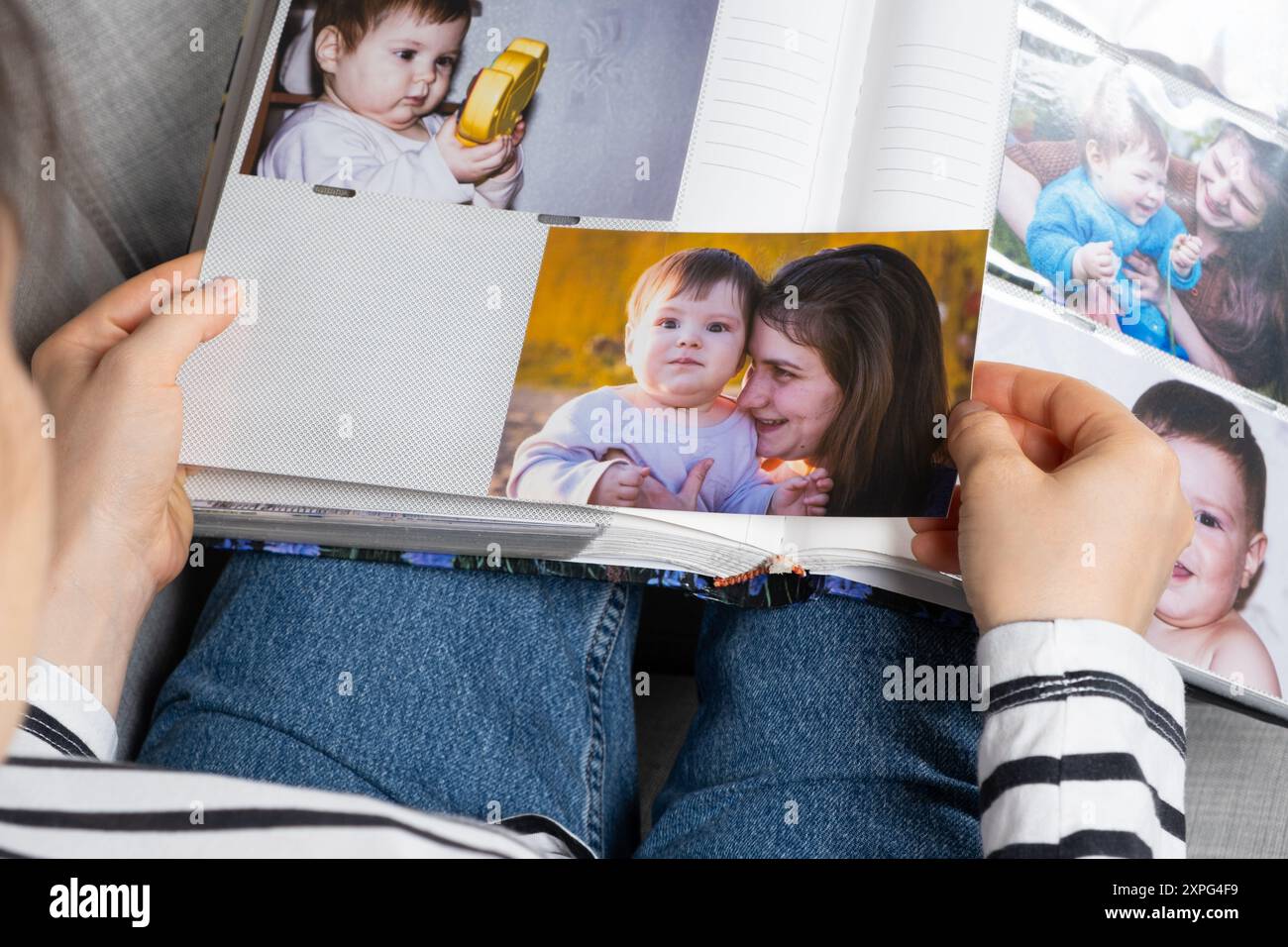 Woman putting photo in photo album Stock Photo - Alamy