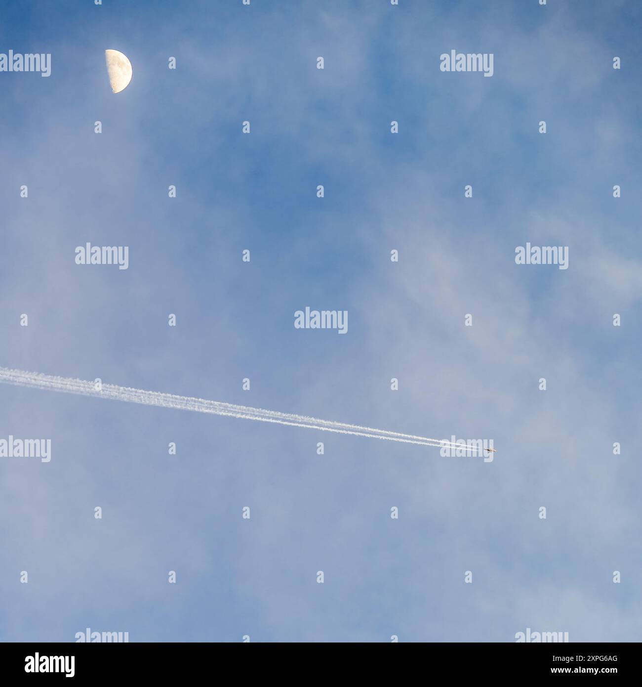 Plane flies pass over the moon on blue sky airplane trail. Amazing ...