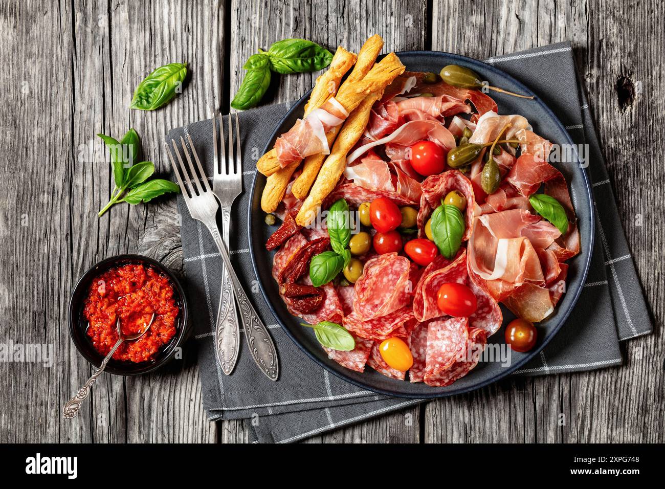 italian antipasto platter of salami slices, parma ham, grissini ...