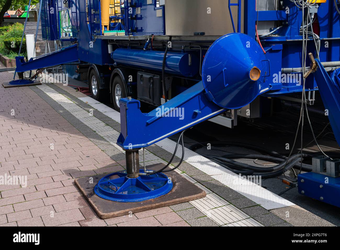 Hydraulic stabilizers are positioned on the ground, ready for use with ...