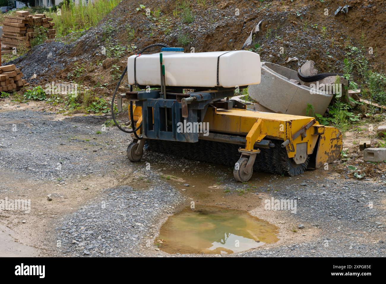 A yellow industrial cleaning machine with a water tank, used for ...