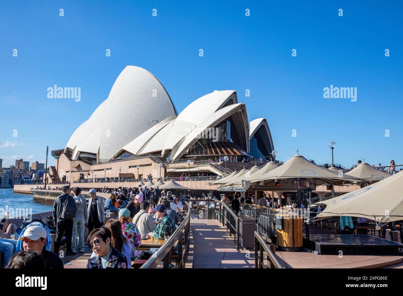 Sydney Opera House blue sky winters day, people relax and enjoy lunch ...