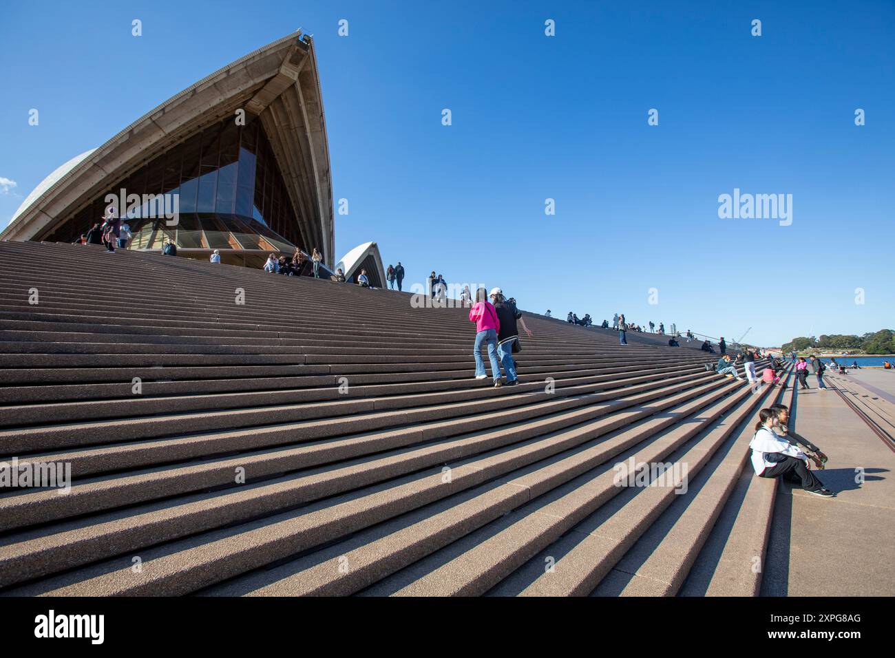 Sydney Opera House, tourists visitors walking up the steps to the Opera ...