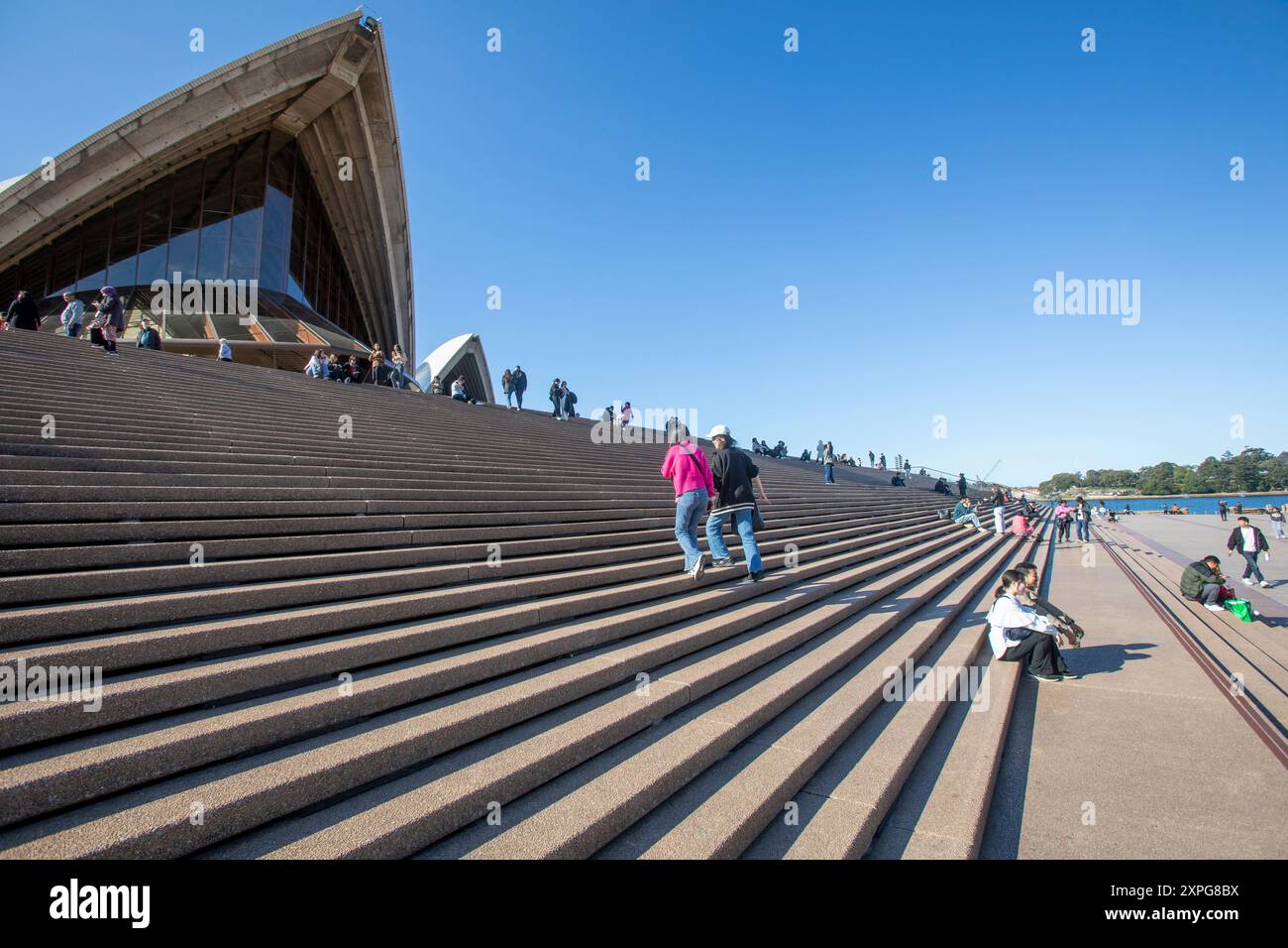 Sydney Opera House, tourists visitors walking up the steps to the Opera ...