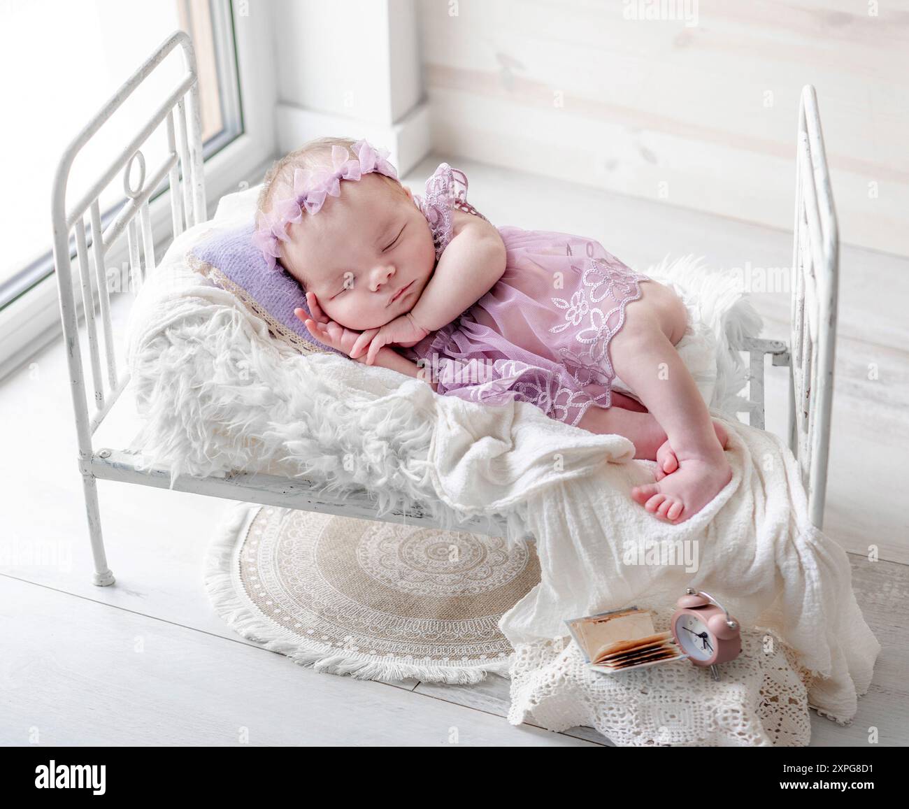 Newborn Girl Sleeps In Tiny Bed During Photo Session In Studio Stock ...