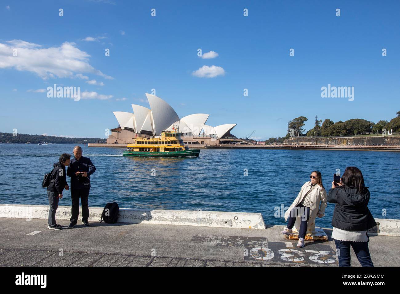 Sydney Opera House, Sydney ferry on the harbour, tourists visitors look ...