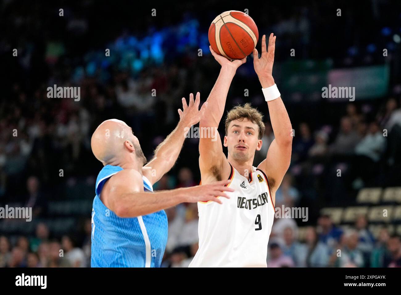 Franz Wagner, right, of Germany, shoots as Nick Calathes, of Greece ...