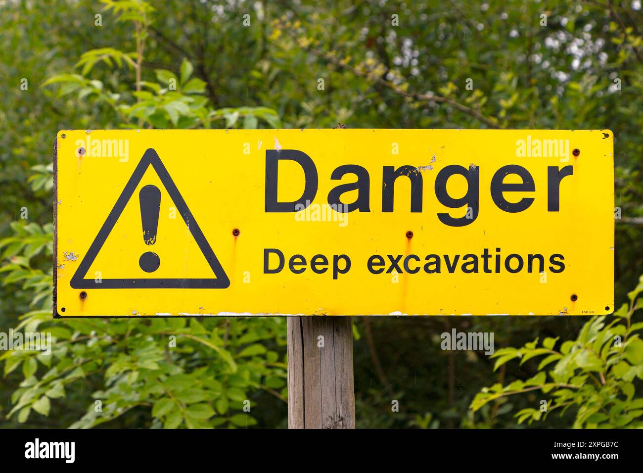 yellow warning sign for deep excavations Stock Photo - Alamy