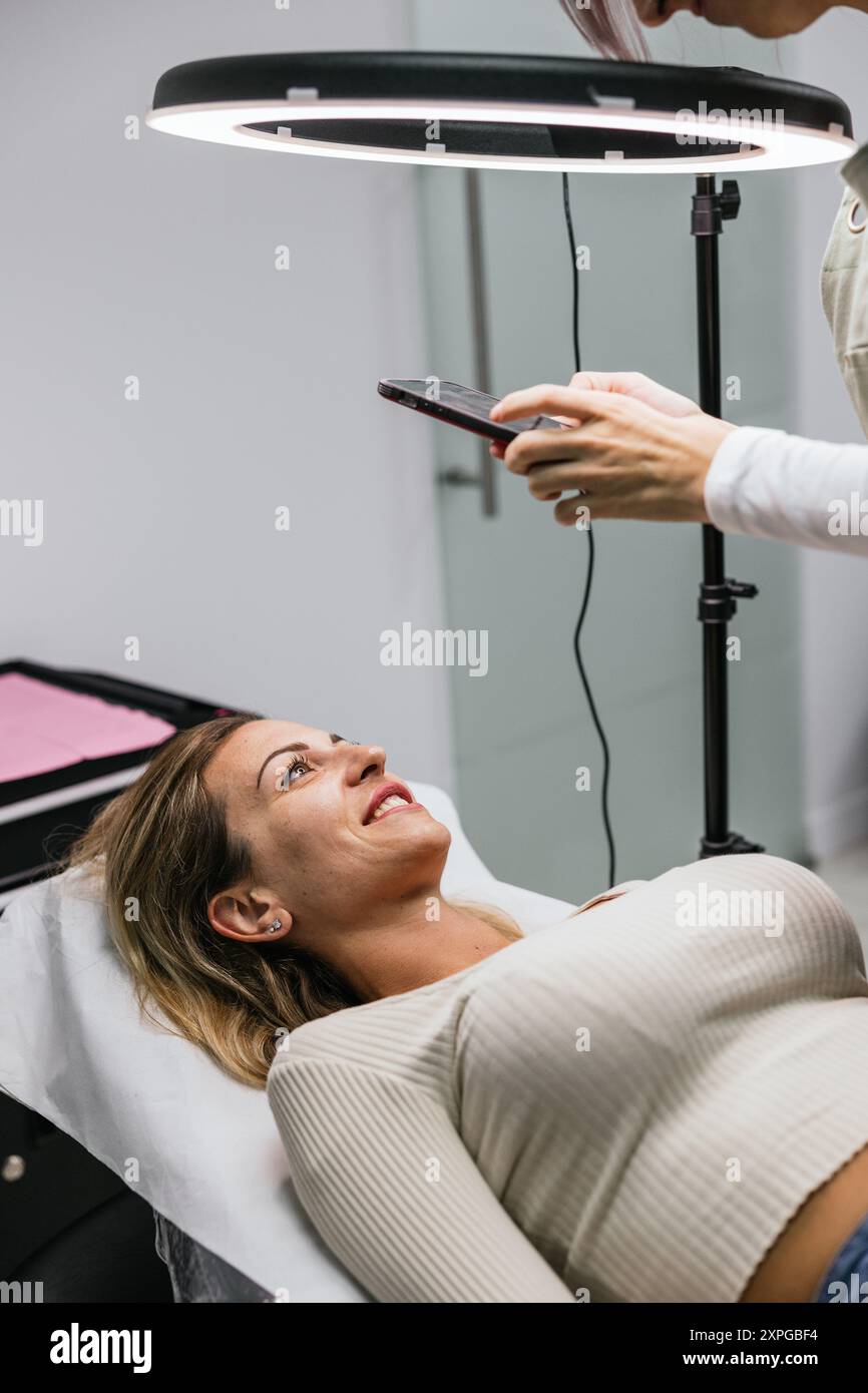 Lip micropigmentation procedure documented for social media Stock Photo ...