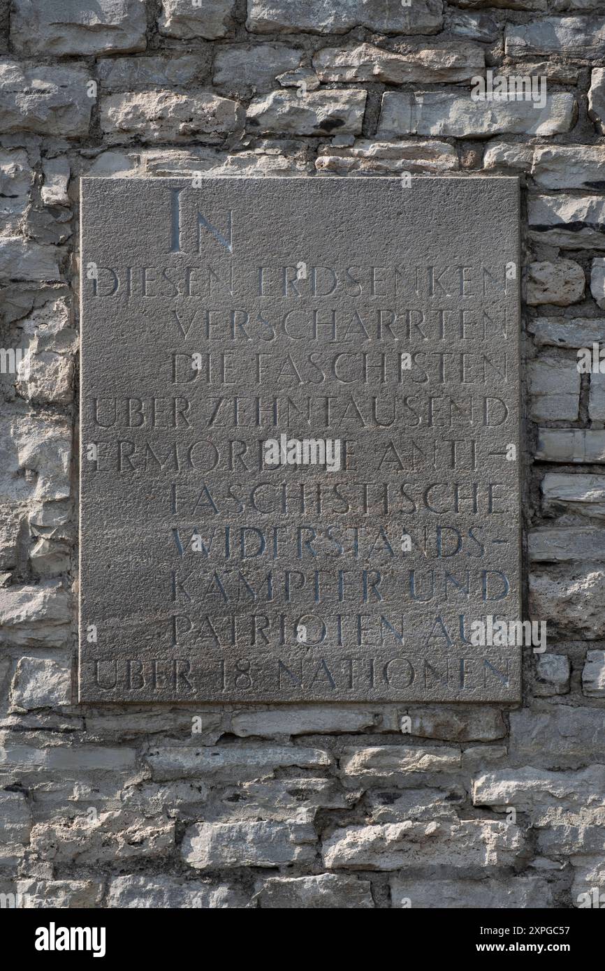 Memorial plaque in the ring-shaped wall around the large burial pit ...
