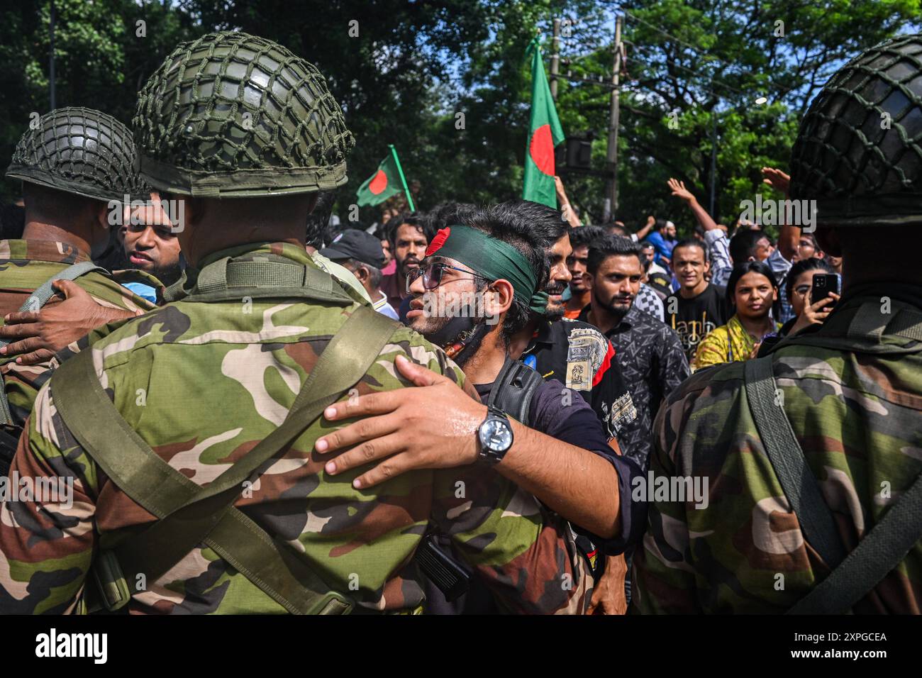 An anti-government protestor celebrates and embraces a soldier in ...