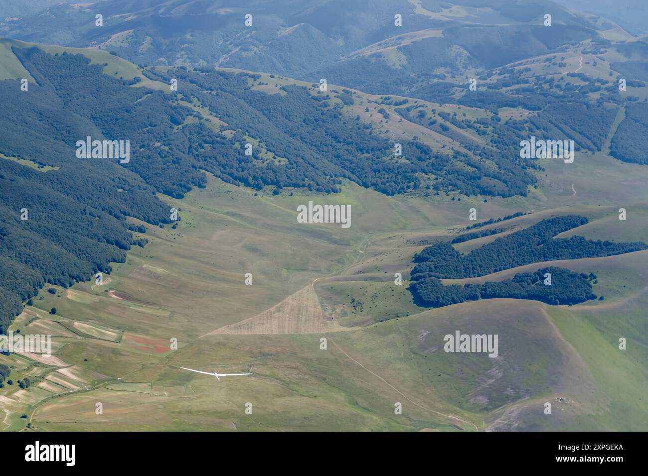 aerial landscape, from a glider plane, with a glider plane in flight ...