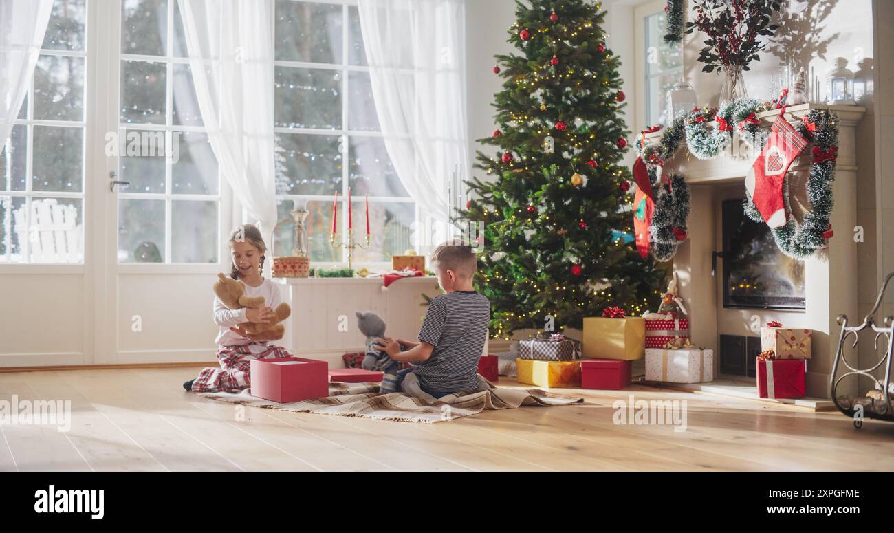 Cute Kids in Pajamas Getting Their Gifts On Christmas Bright Morning ...