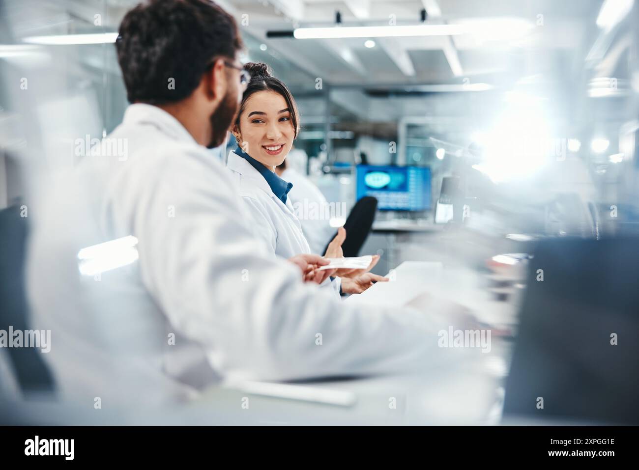 Laptop, scientist and colleagues with smile, medical research and ...