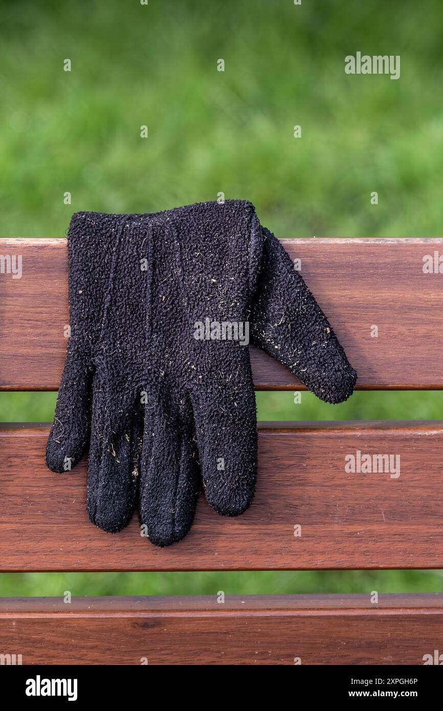 A lost glove draped over a bench Stock Photo - Alamy