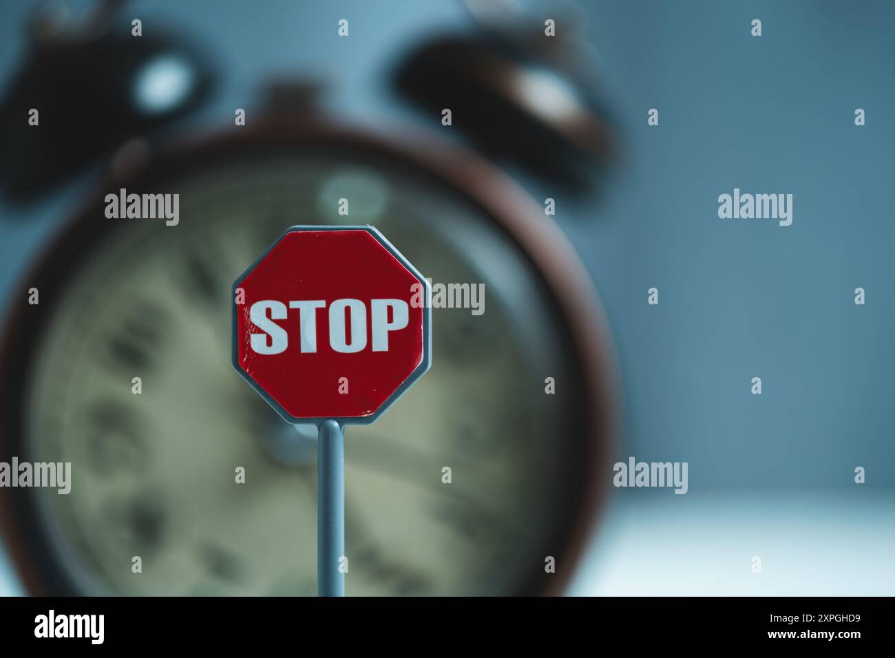 Stop sign and alarm clock on blue background. Stop time concept Stock ...