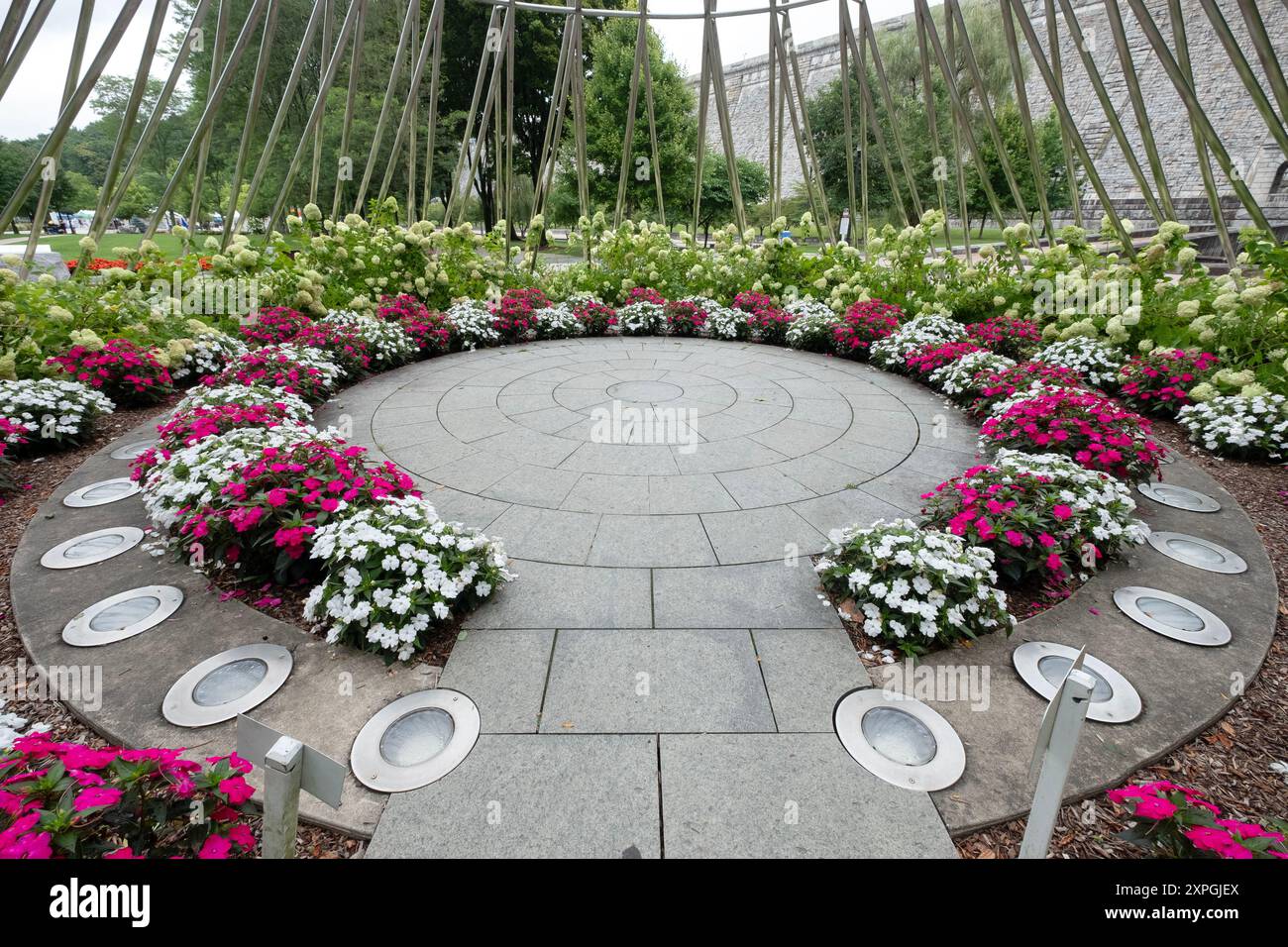 Ornate flowers arranged at the base of The Rise, a statue in Kensico ...
