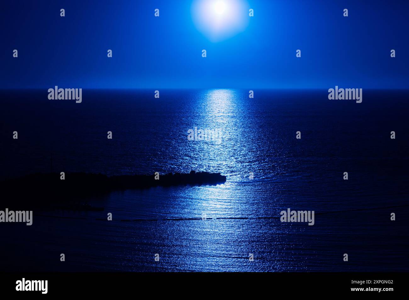 Captivating moon rising over the blue ocean. Calm ocean with a bright ...