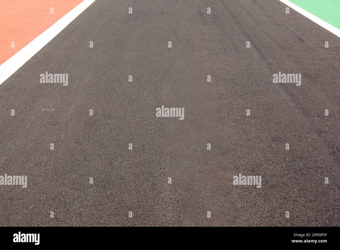 Asphalt track bordered by white lines Stock Photo - Alamy