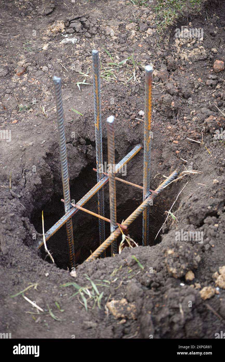 Rebar installed in the hole in the ground for the foundation of ...