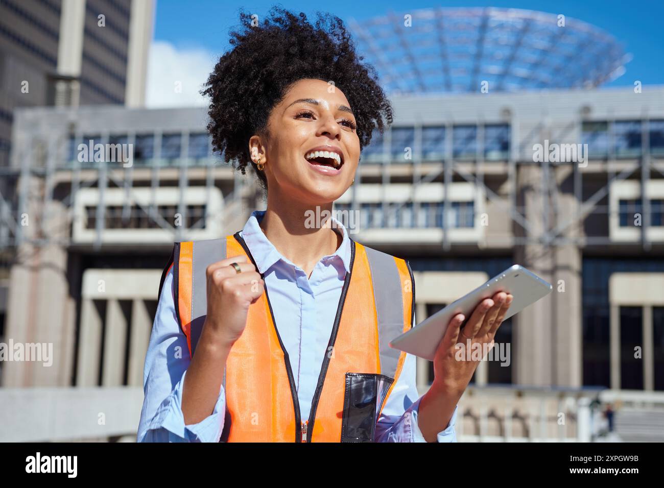 Smiling Female Engineer Celebrating Success at a Modern Construction ...