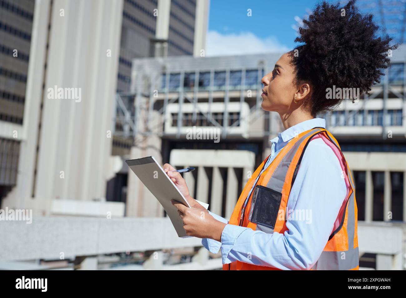 Female Construction Worker Inspecting Building Site with Clipboard ...