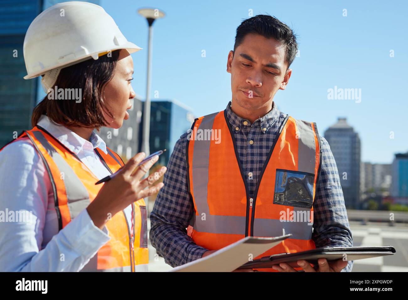 Diverse Construction Team Discussing Project Plans on a City Building ...
