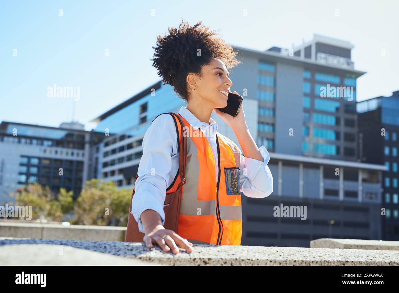 Confident Female Construction Worker Using Phone Outdoors in Modern ...