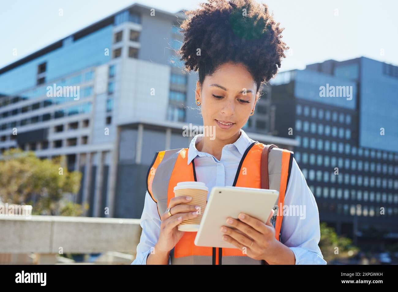 Confident Female Construction Worker Using Tablet on Worksite with ...