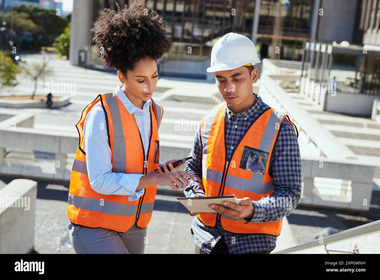 Diverse Construction Workers Reviewing Plans on a City Project Stock ...