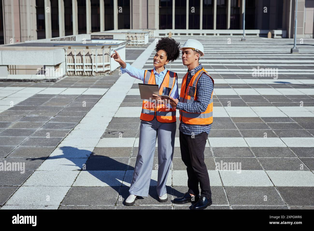 Diverse Construction Team Discussing Project Plans on Site Outdoors ...