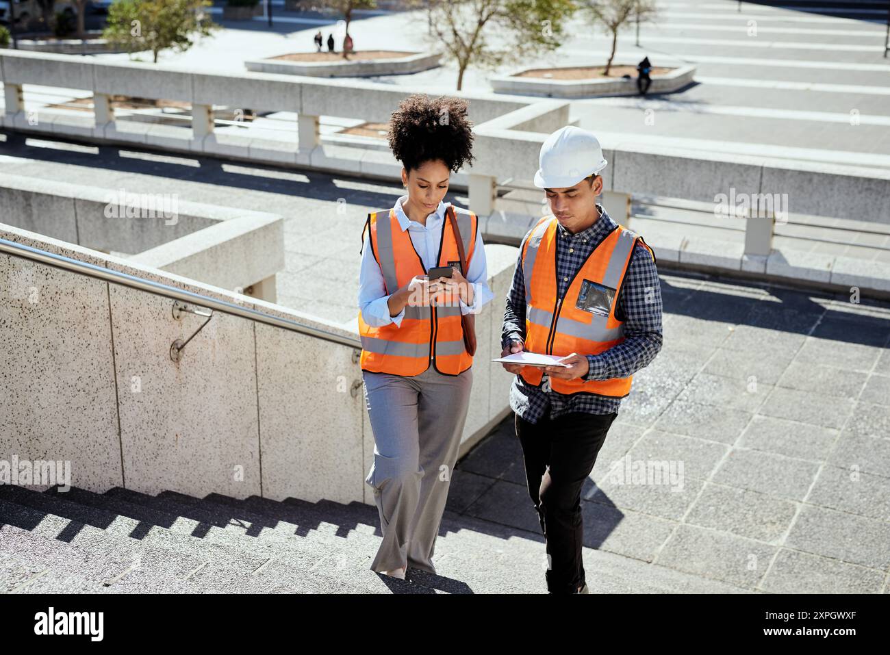 Diverse Construction Workers Collaborating with Digital Devices on ...