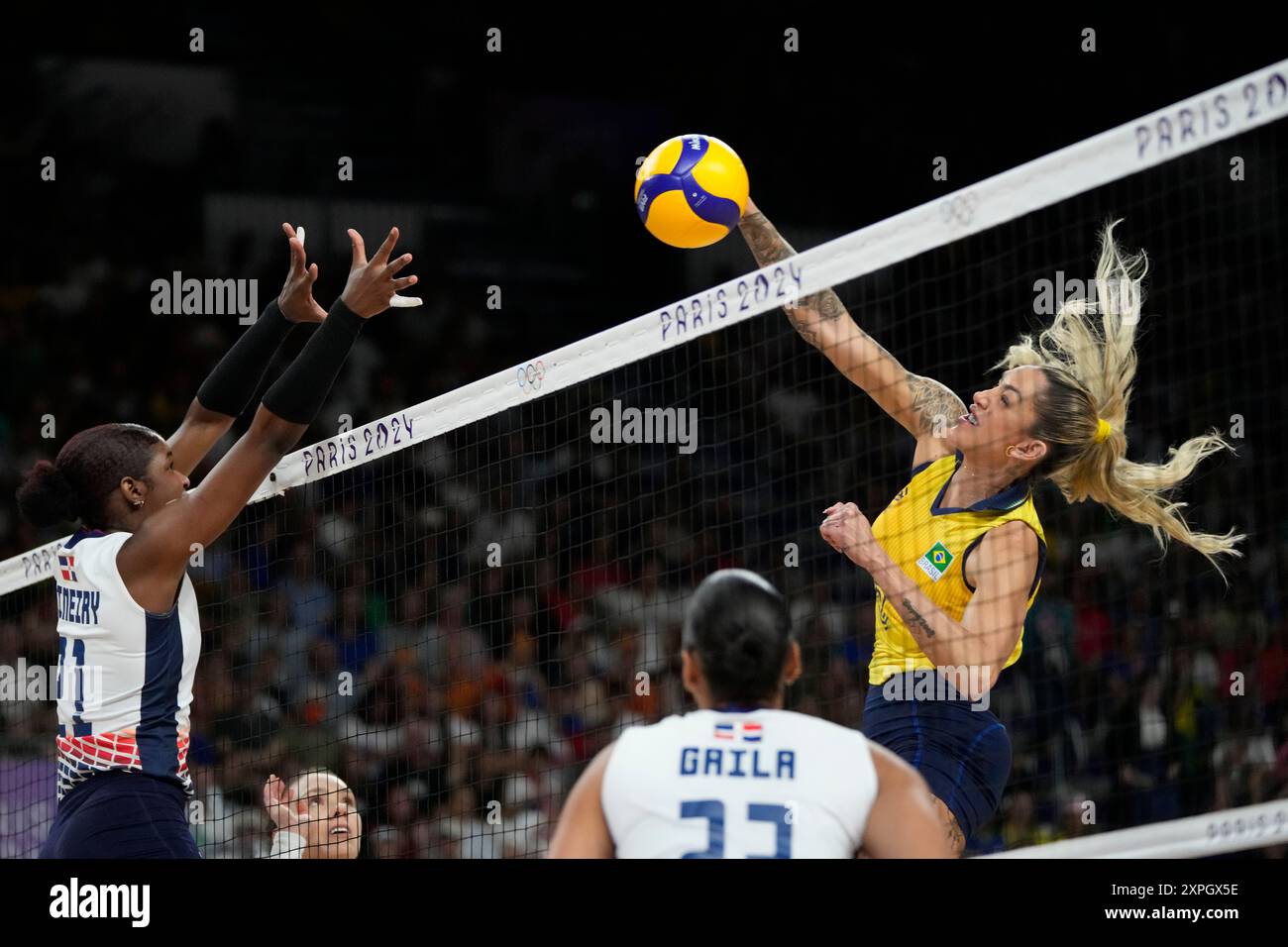 Thaisa Daher of Brazil spikes the ball during a women's quarter final ...
