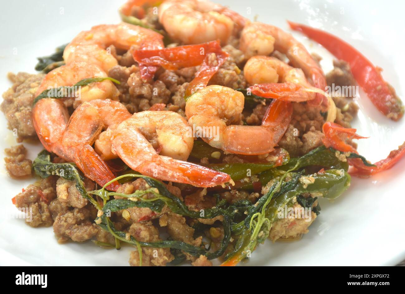 spicy stir fried chop pork with chili and basil leaf topping shrimp on ...