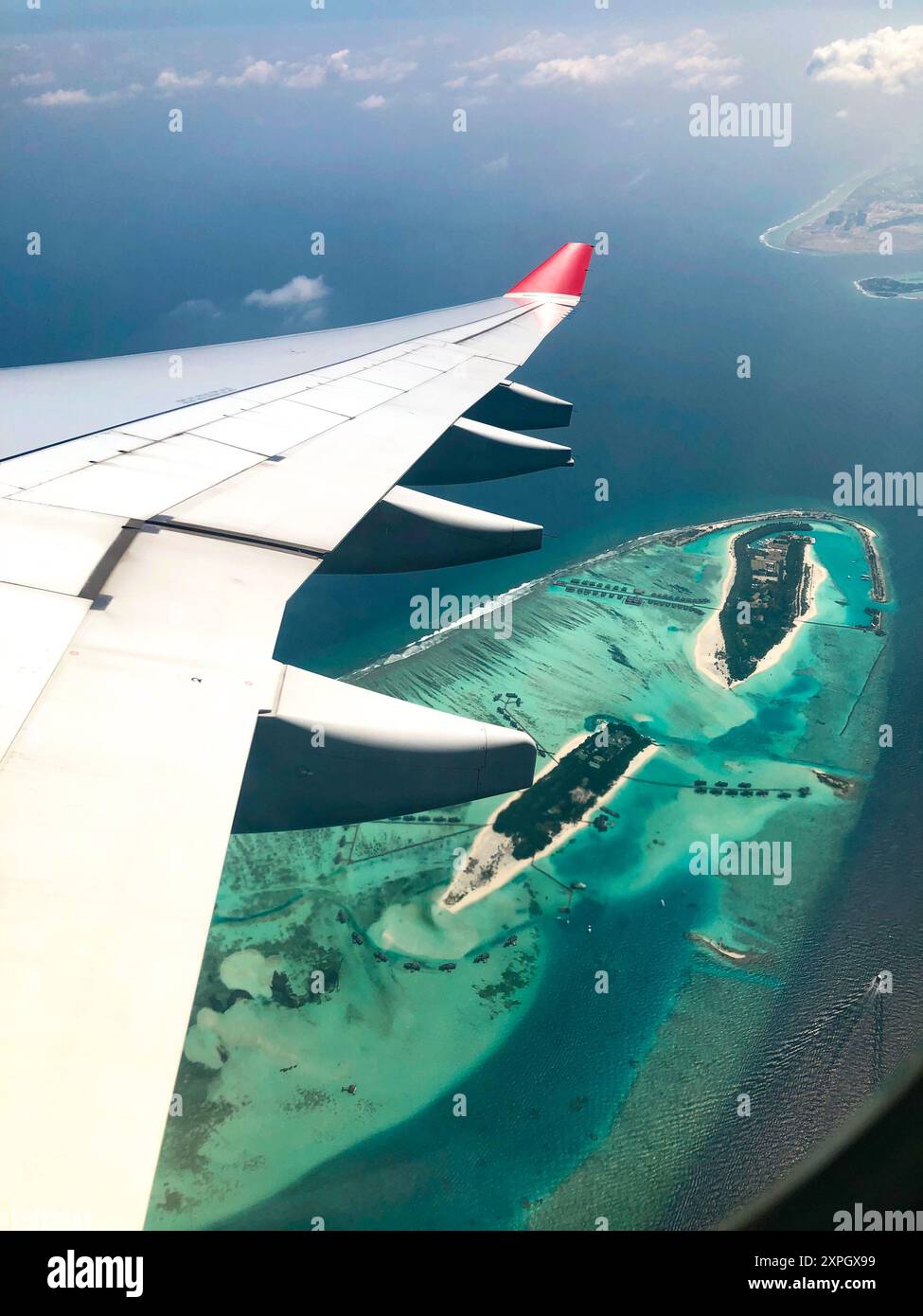 Maldives islands top view from airplane window with airplane's wing ...