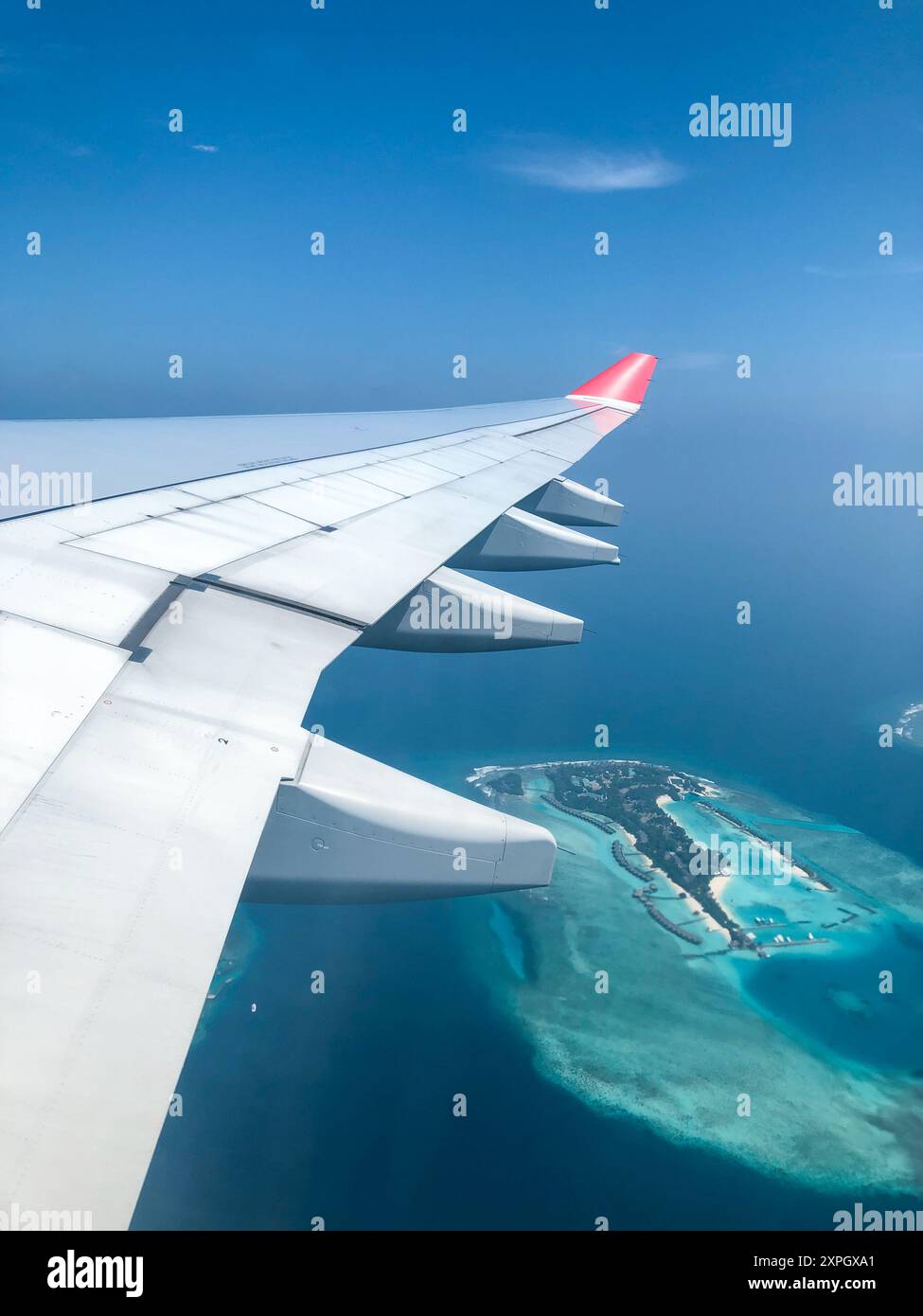 Maldives islands top view from airplane window with airplane's wing ...