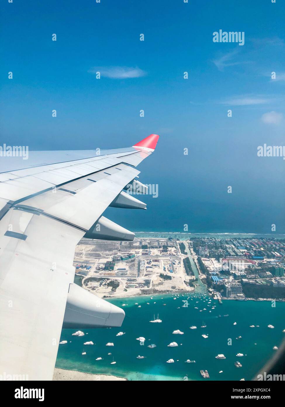 Maldives islands top view from airplane window with airplane's wing ...