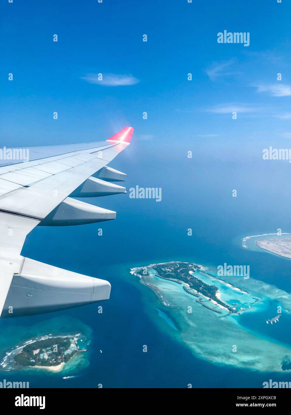 Maldives islands top view from airplane window with airplane's wing ...