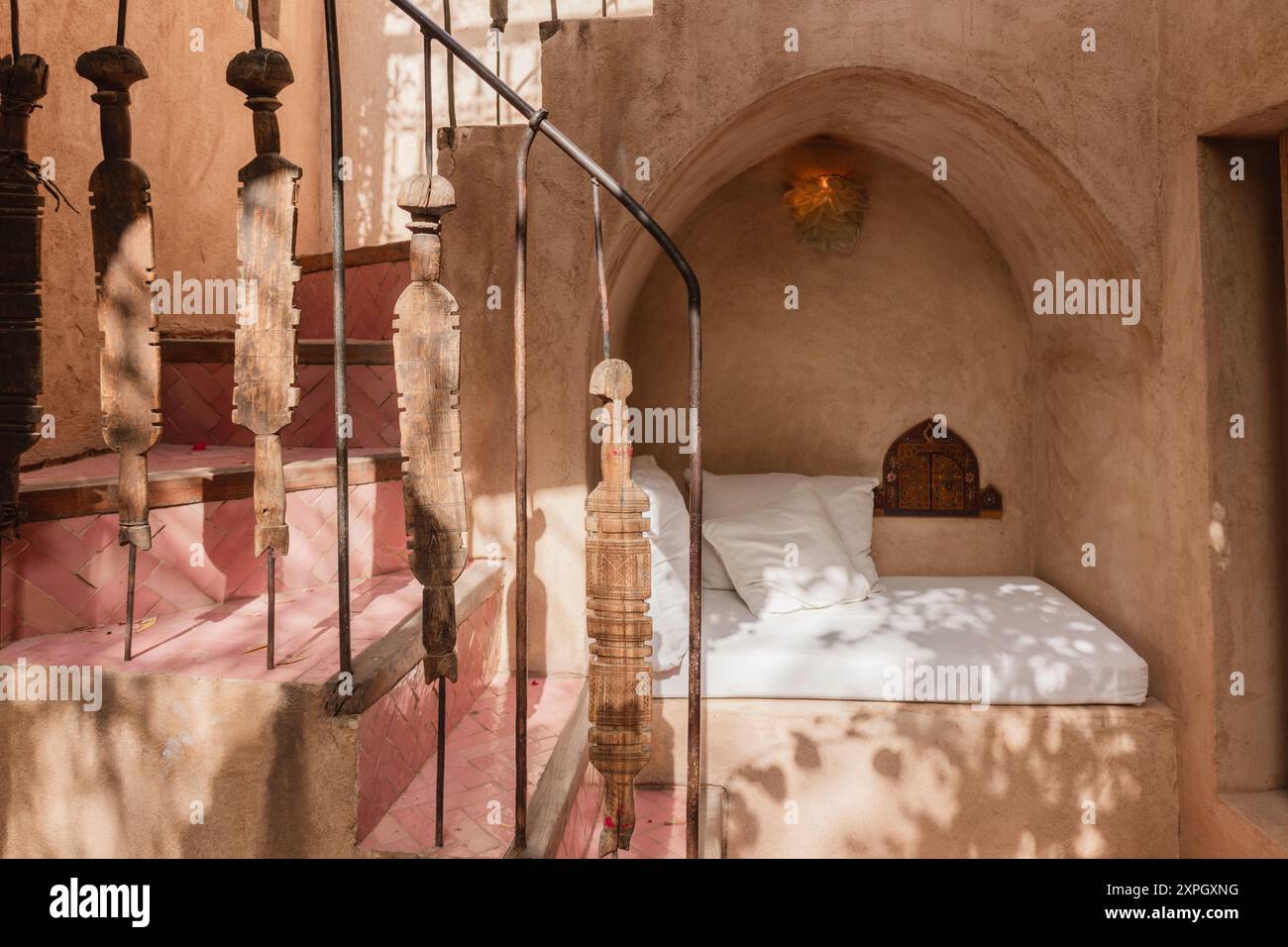 cozy nook in a traditional riad in Marrakech, with rustic tiled pink ...