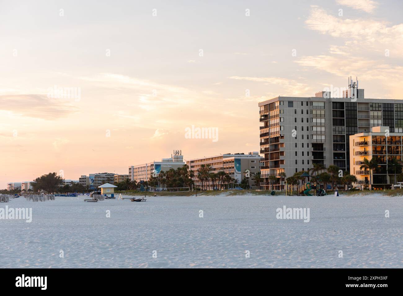 A cityscape sunset down St. Pete Beach with the buildings being lit up ...