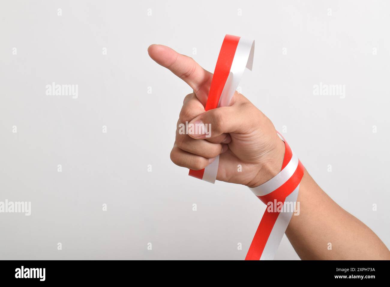 Hand pointing one finger with red and white ribbon as symbol of ...