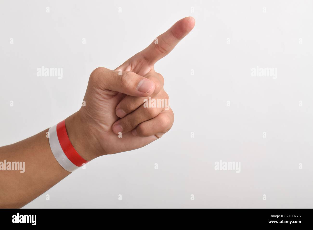 Man's hand pointing one finger with red and white ribbon as symbol of ...
