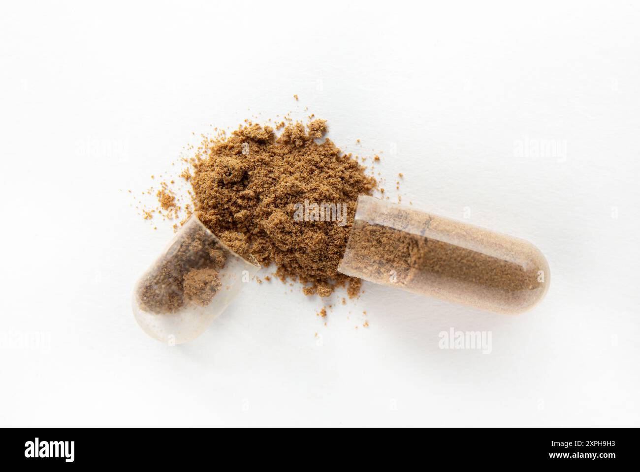 Macro photo of the open capsule with brown powder isolated on white ...
