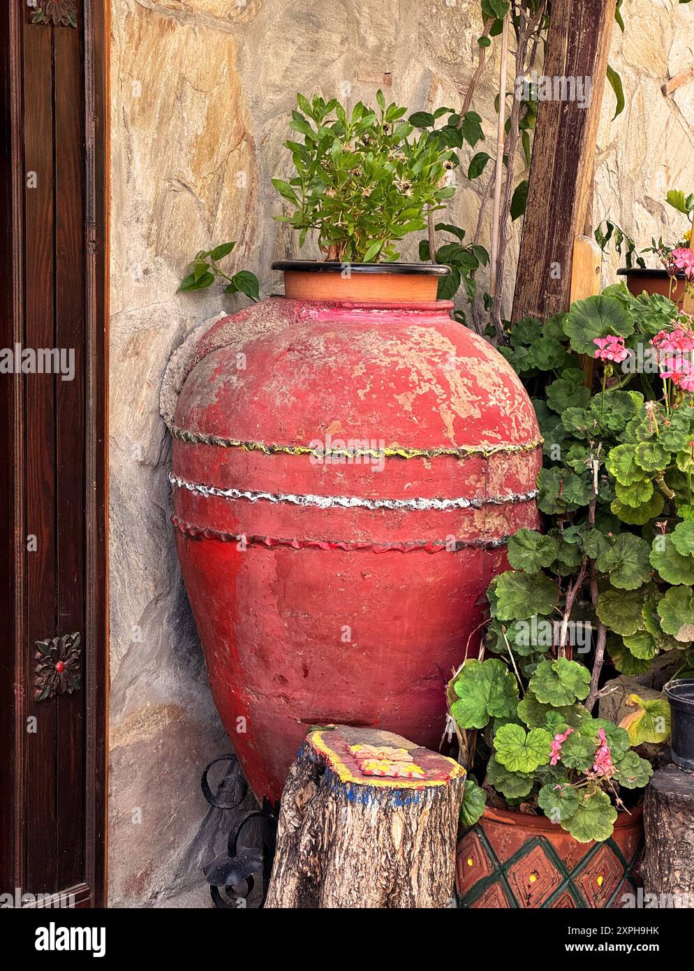 Ancient pottery vessel surrounded by potted plants in Izmir, Turkey ...